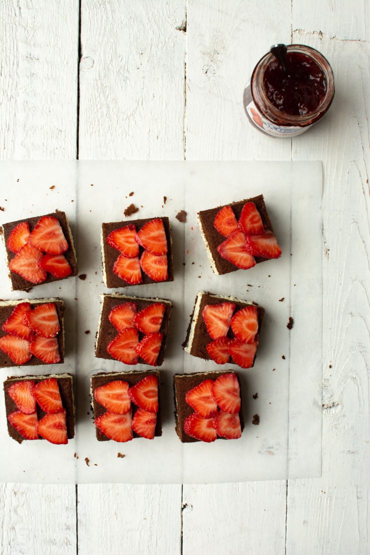Chocoladecakejes met jam, slagroom en verse aardbeien